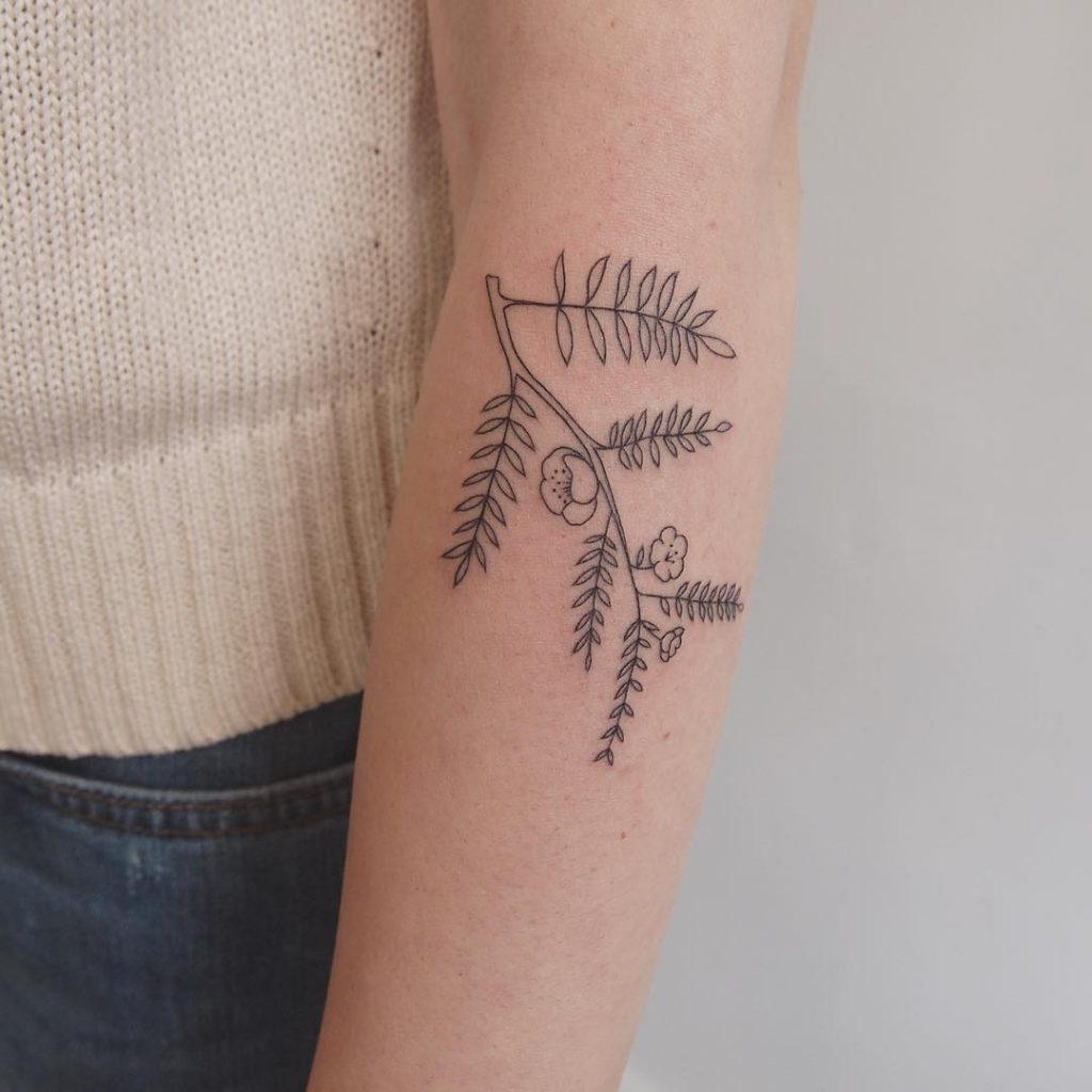 Minimalist fern leaf tattoo on the forearm - Tattoogrid.net