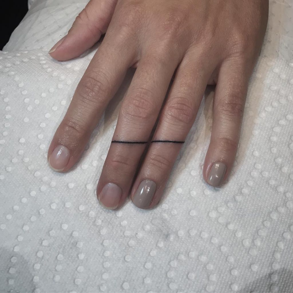 Hand-poked moon tattoo on the ring finger - Tattoogrid.net