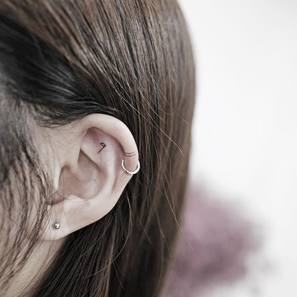 Ornamental ear tattoo by Remy B - Tattoogrid.net