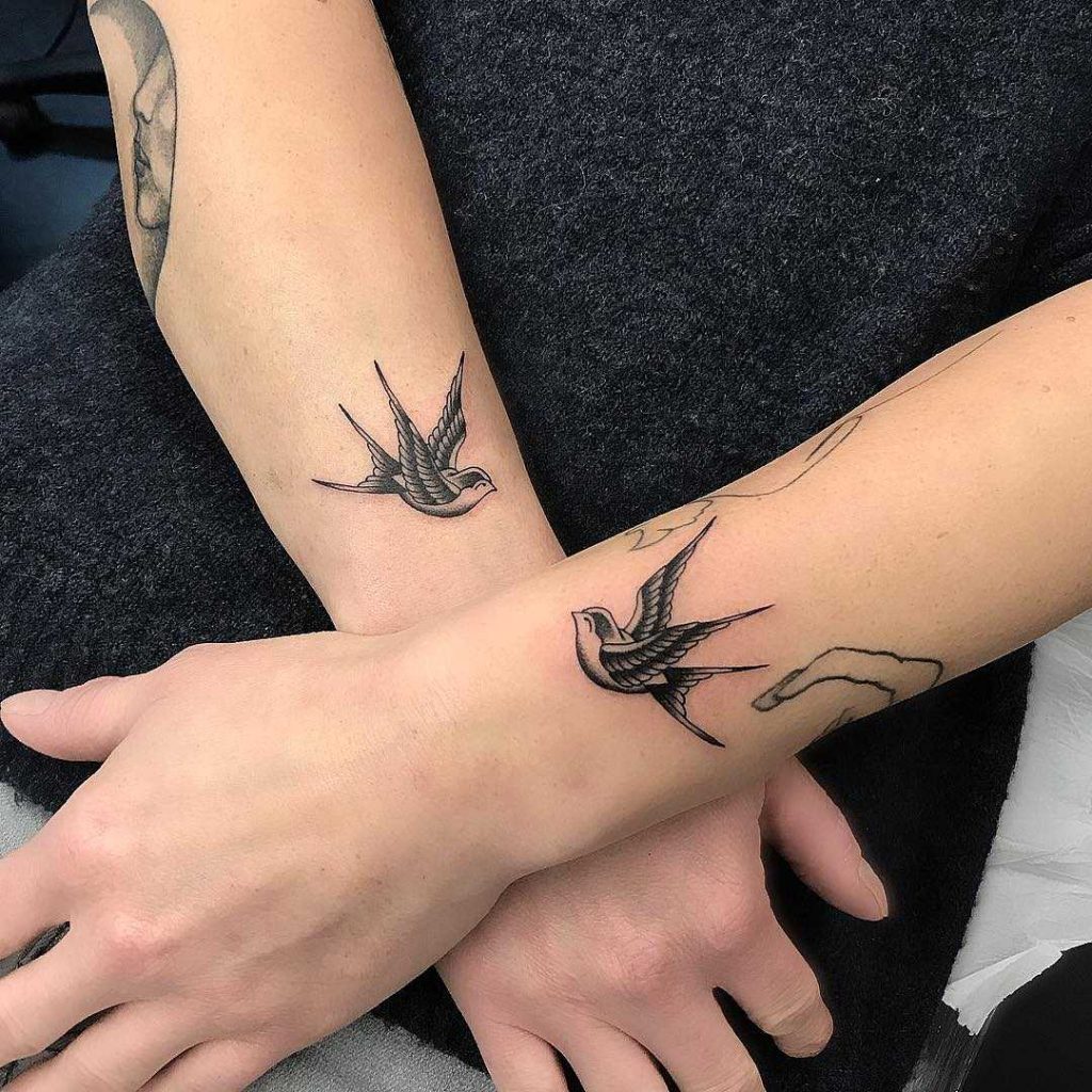 Matching swallow tattoos by Totemica - Tattoogrid.net